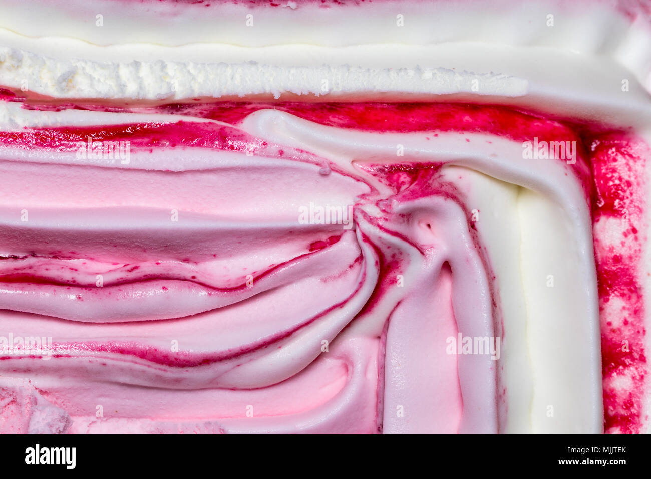 Background texture of swirling pink Italian ice cream with a ridged ...