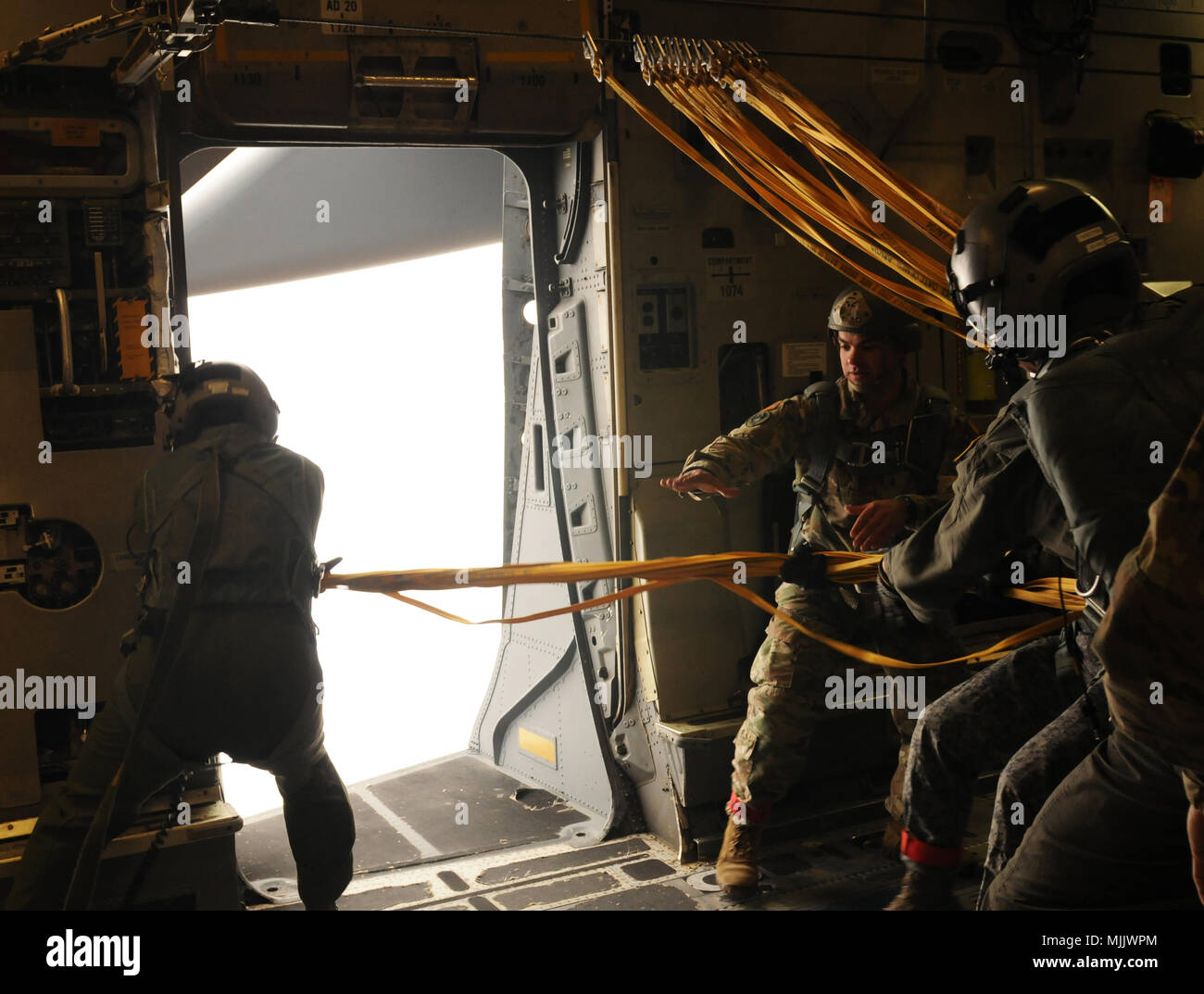 U.S. Air Force loadmasters and Army jumpmasters pull in the universal ...