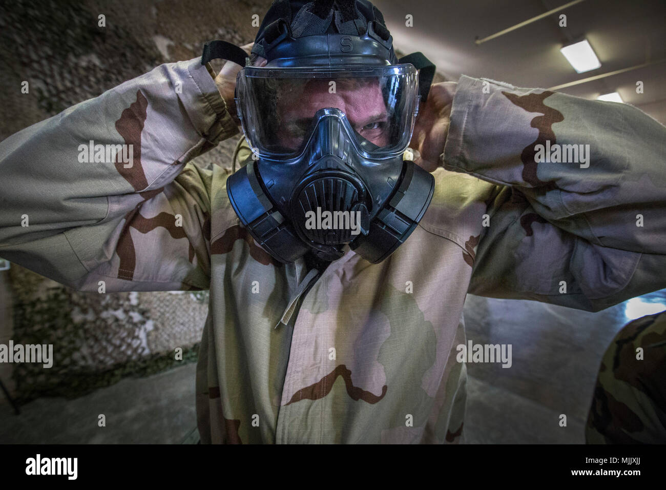 A U.S. Air Force Airman with the 514th Air Mobility Wing dons his M-50 ...