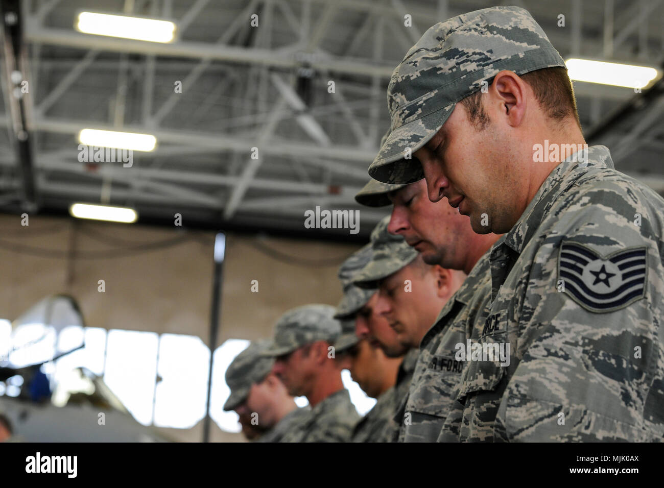 Airmen bow their heads during an Assumption of Command ceremony, Dec. 3 ...