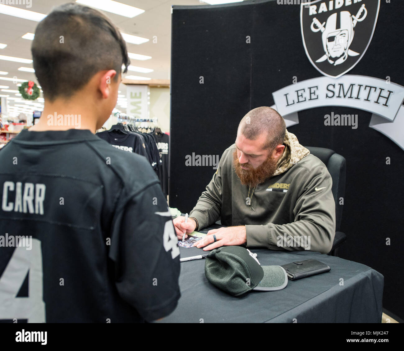 Oakland Raiders tight end Lee Smith signs an autograph for a fan during ...
