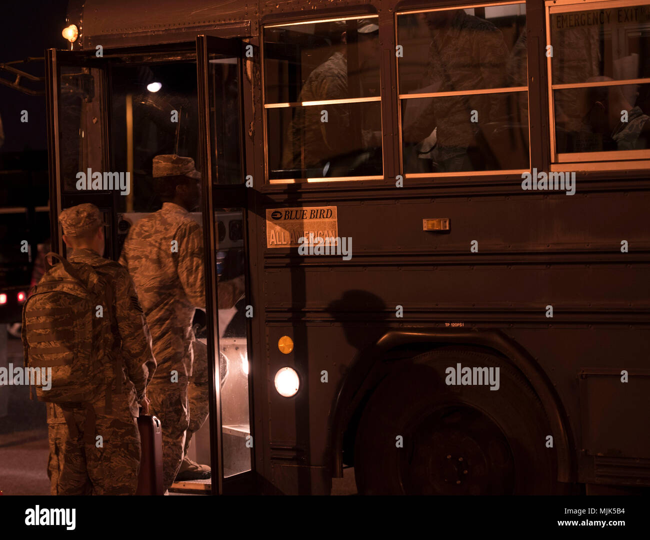 U.S. Air Force Airmen get onto a bus after a non-combatant evacuation ...