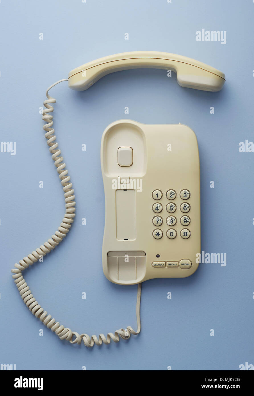 Vintage home telephone over blue background, above view. This image is ...