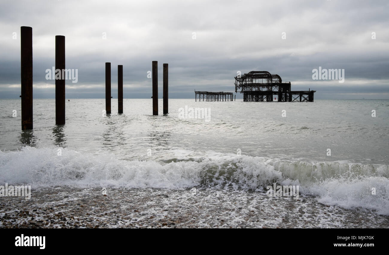 A carcass of burned down old Brighton pier on a grey cloudy day Stock ...