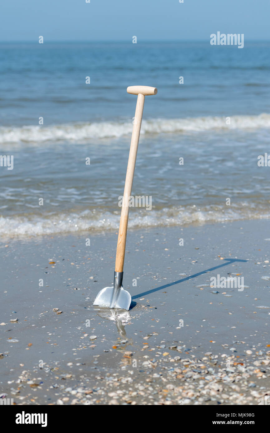 Shovel in the sand from the North Sea Beach Stock Photo - Alamy