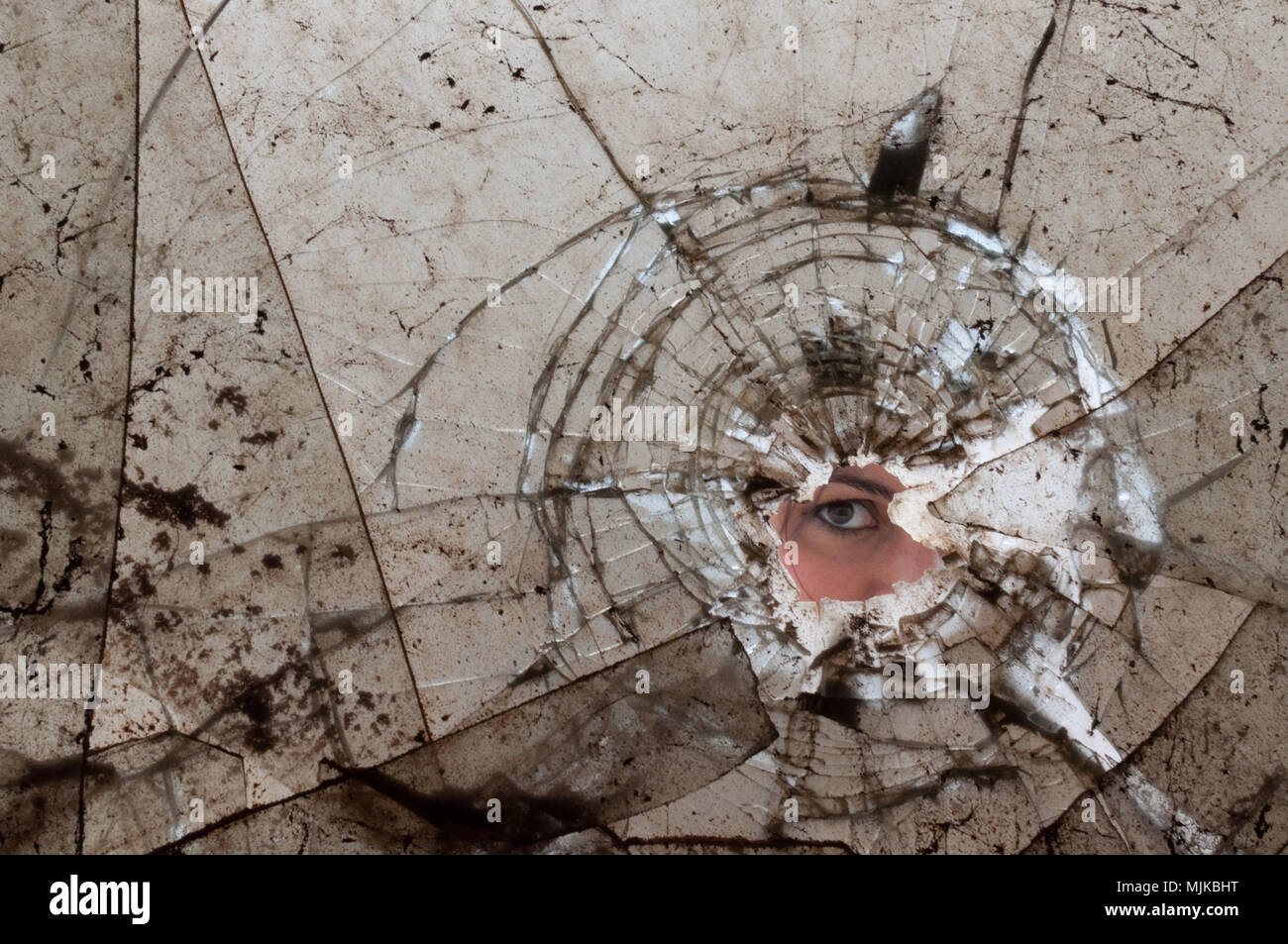 woman eye looking through dirty broken window Stock Photo - Alamy