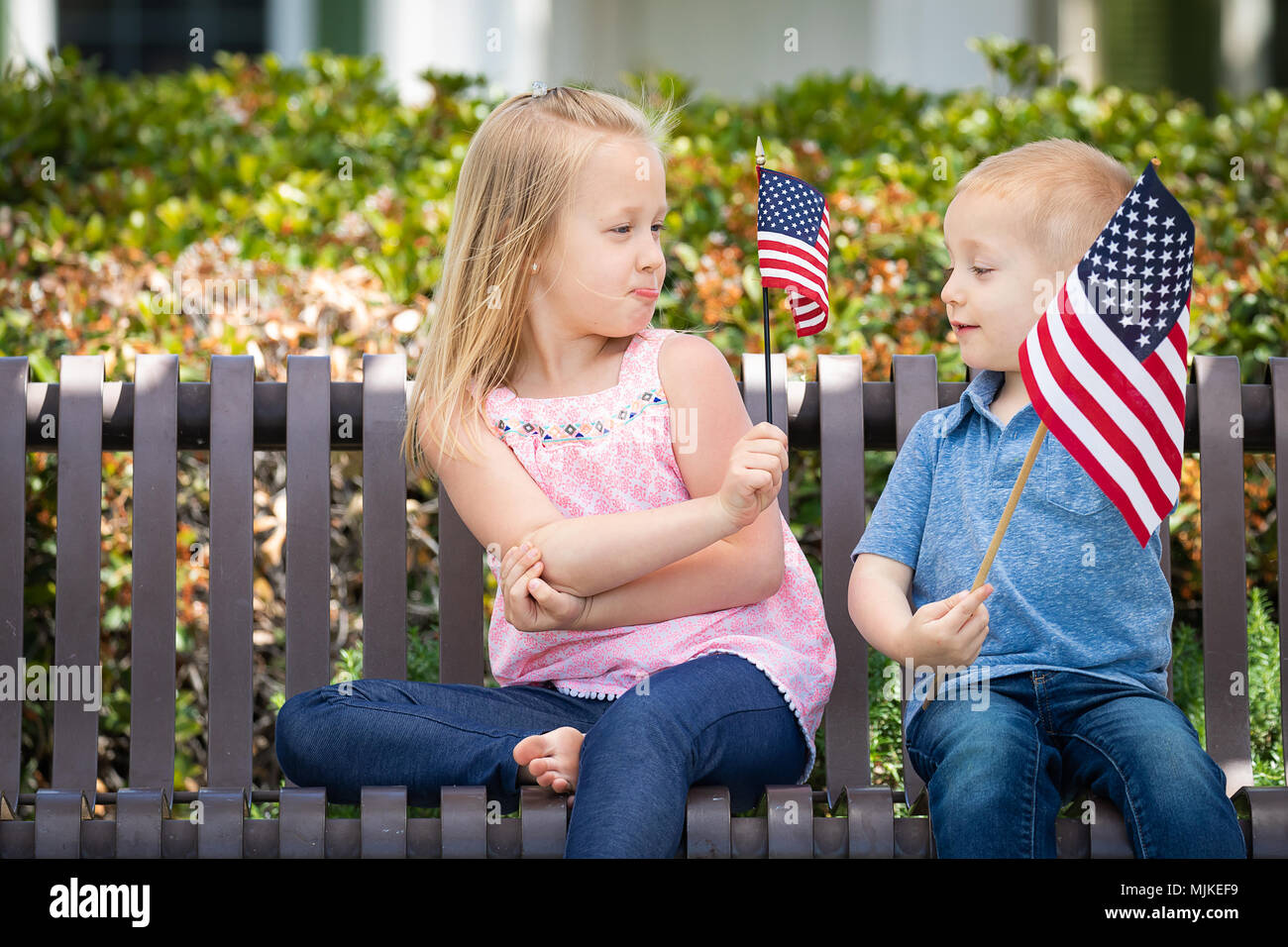 Young Sister and Brother Comparing Each Others American Flag Size On ...