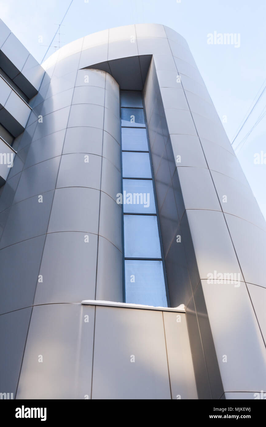 Close-up part of a modern building with a smooth facade. Low angle of ...