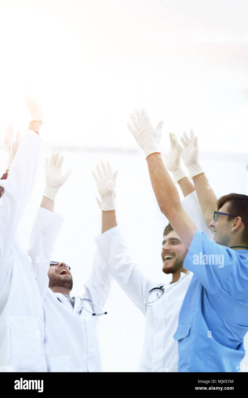 surgical team raising their hand Stock Photo - Alamy