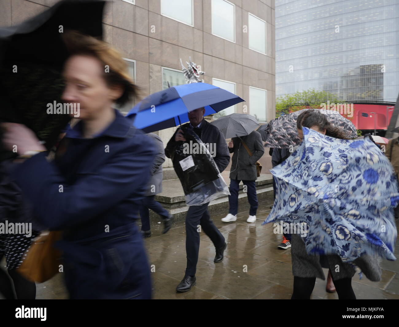 Commuters on London bridge during morning rain storm Stock Photo - Alamy