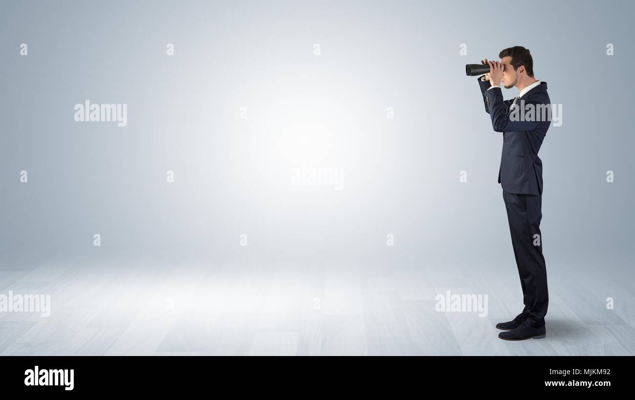 Businessman looking forward with binoculars in an empty space Stock ...