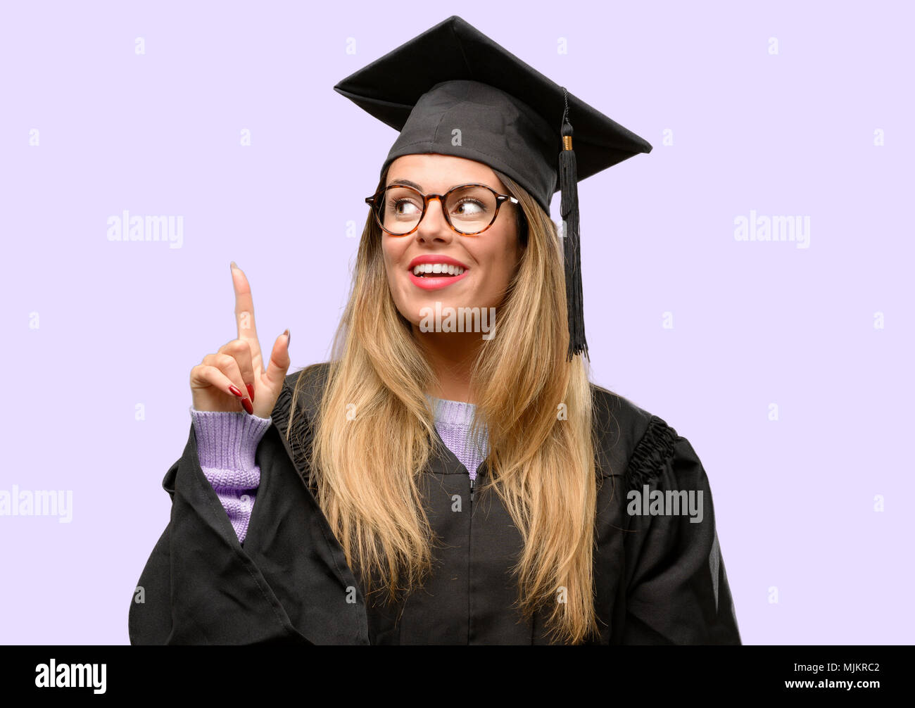 Young woman university graduate student happy and surprised cheering ...