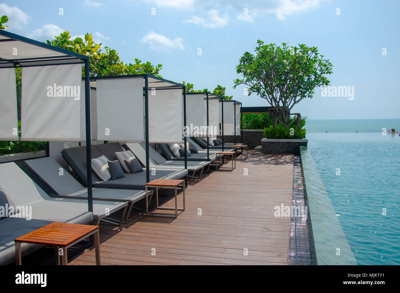 Beautiful luxury Chairs by the swimming pool in hotel Stock Photo - Alamy