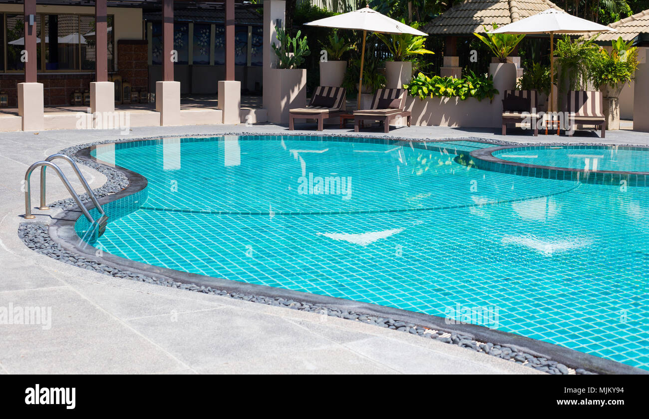 Luxury swimming pool on summer and holiday season Stock Photo - Alamy
