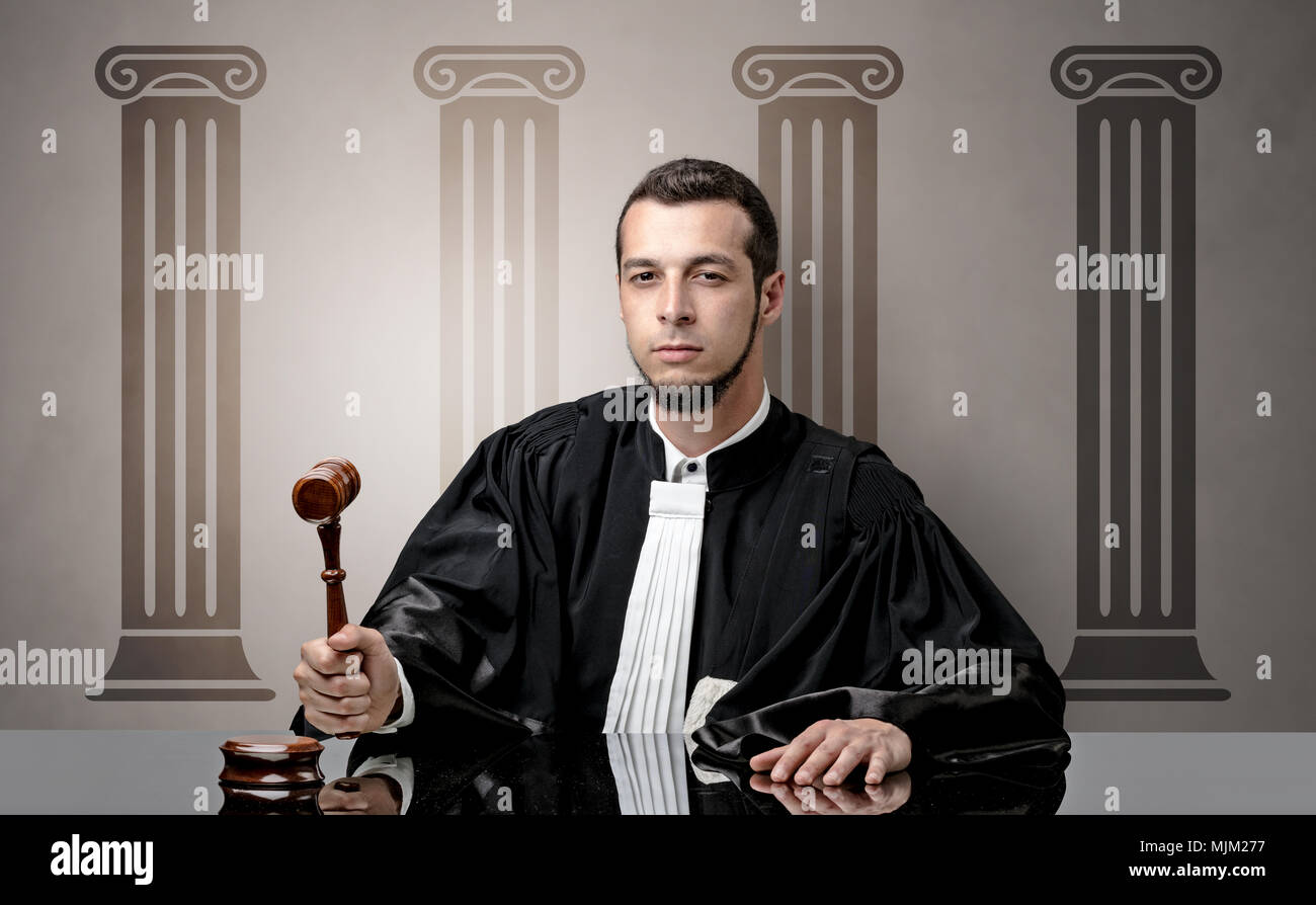 Young judge in front of a courthouse symbol making decision Stock Photo ...