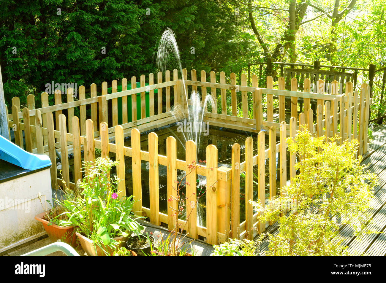 Fish pond surrounded with a wooden fence Stock Photo - Alamy