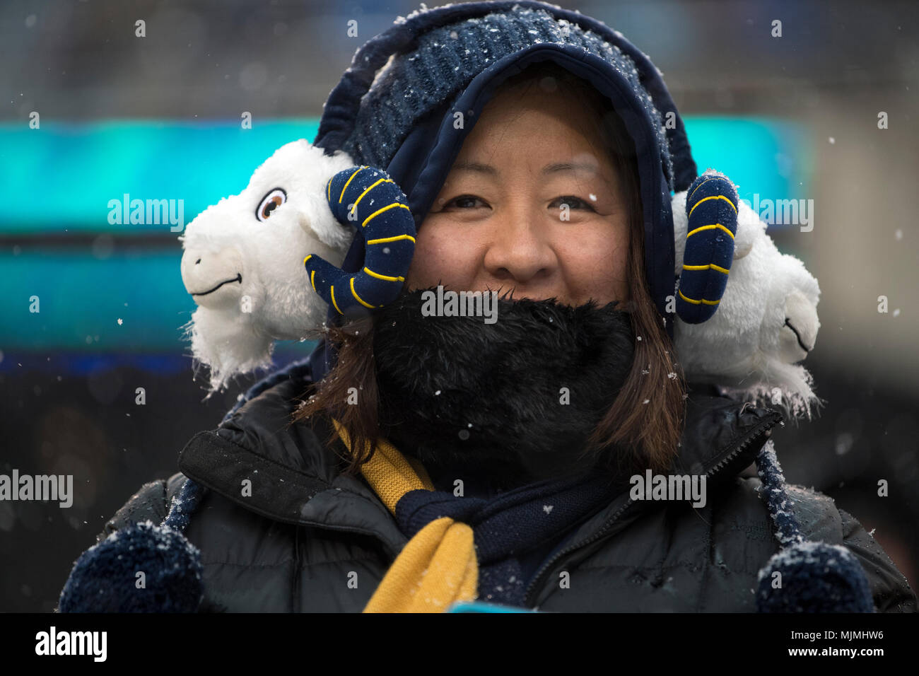 A Navy fan wears United States Naval Academy mascot earmuffs during the ...