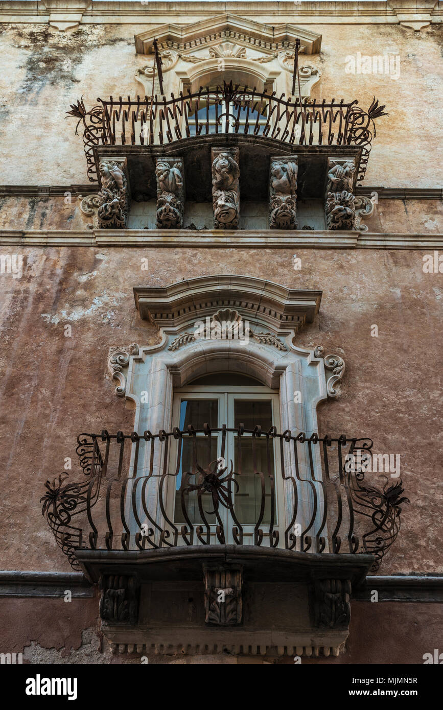 Sculptures of fantastic figures on the cornice of a balcony in the ...