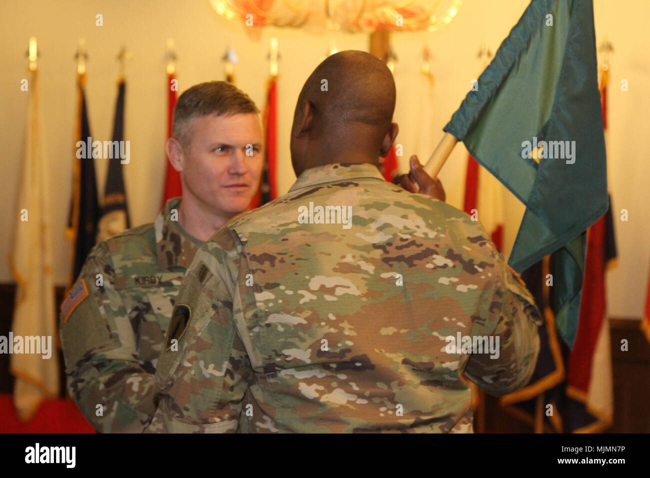 Col. William L. Kirby, commander of the 19th Battlefield Coordination Detachment, hands the ...