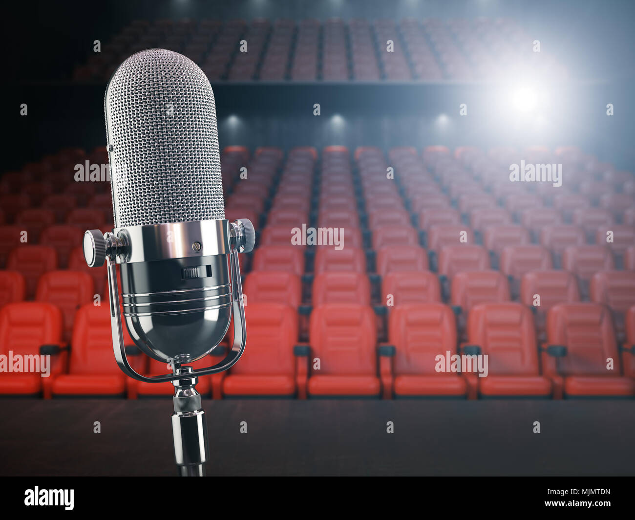Vintage microphone on the stage of concert hall or theater with red ...