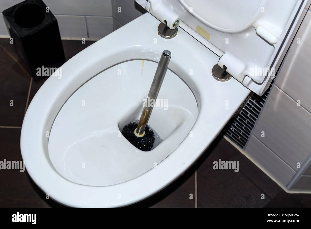 Cleaning a toilet with a toilet brush Stock Photo - Alamy