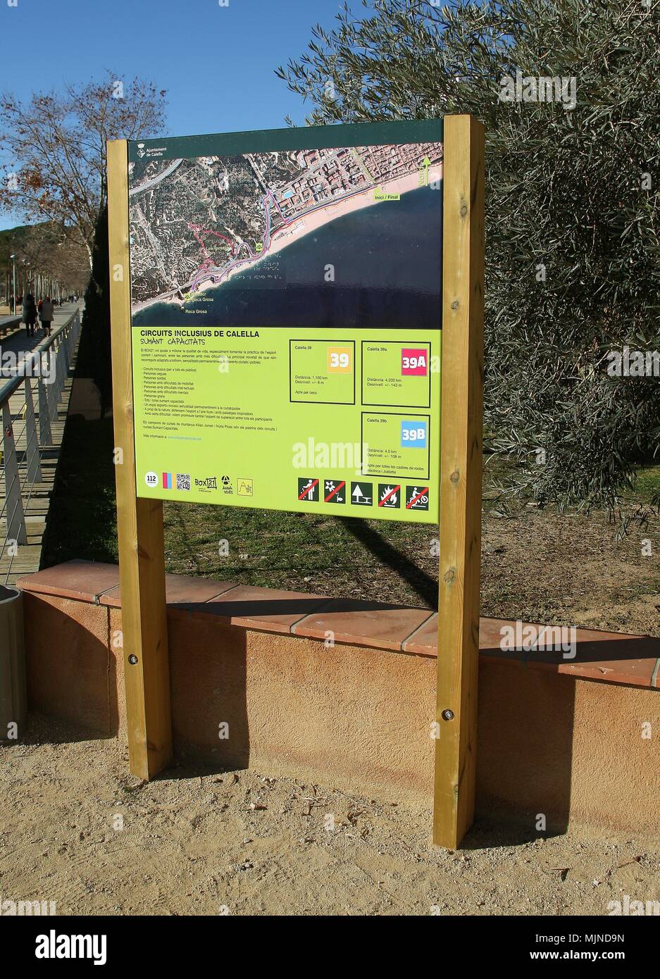 Tourist information sign on the beach in the seaside city of Calella on ...