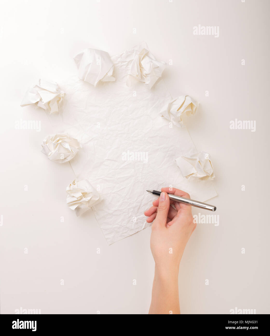 Female hand trying to write next to a few crumpled paper balls Stock ...
