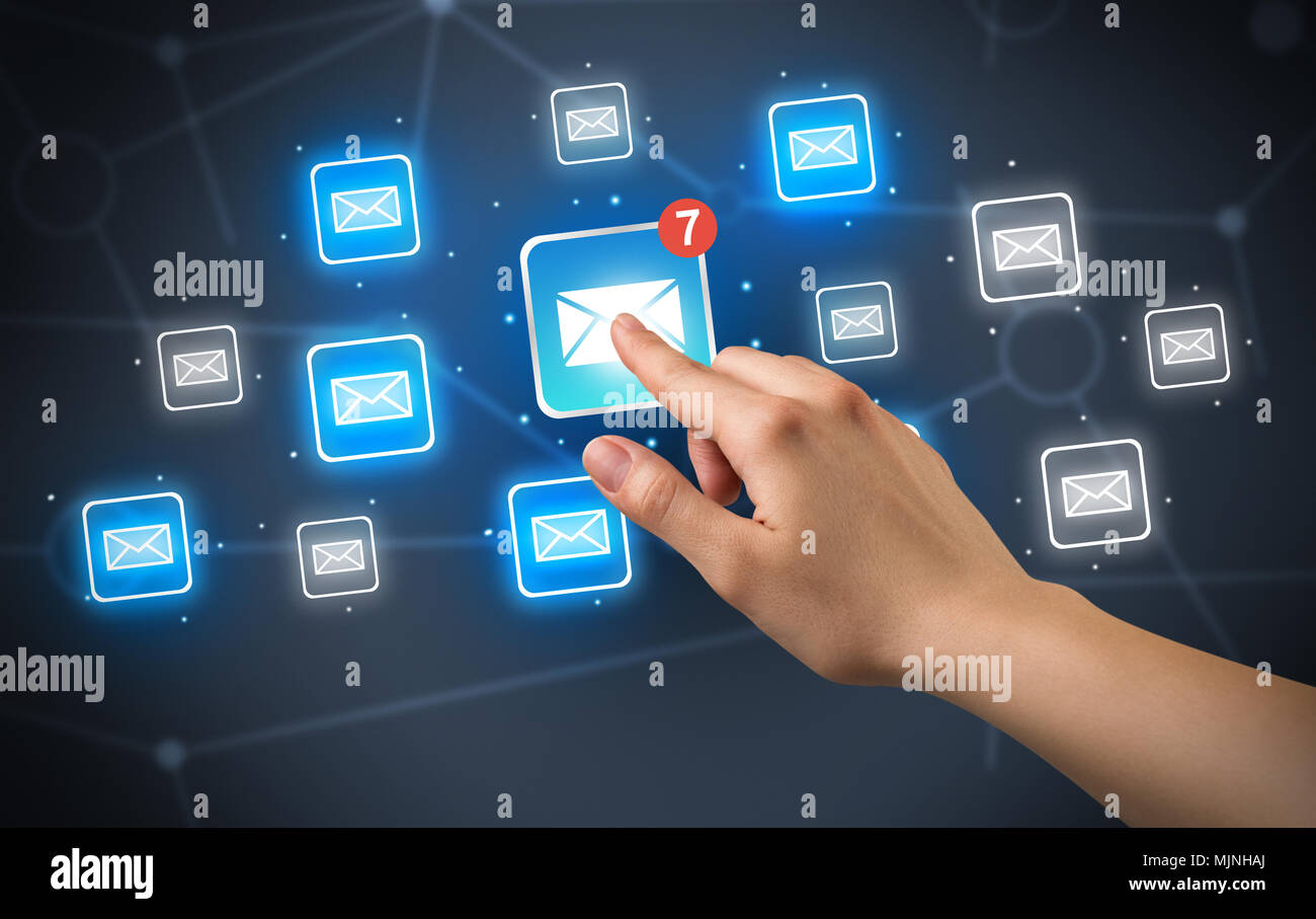 Female hand touching unread mail icon with more envelope icons around ...