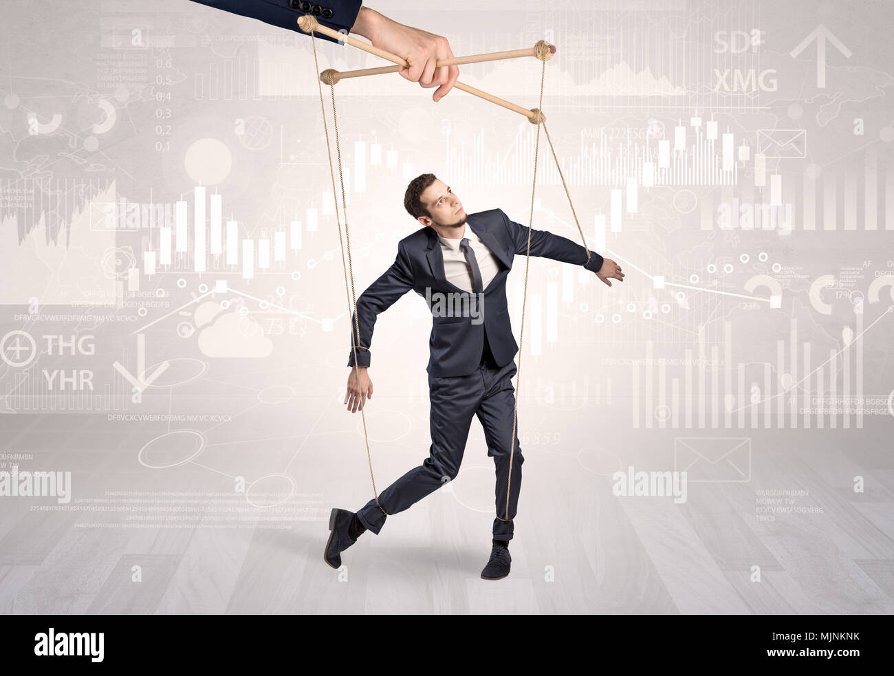 Puppet businessman controlled by another hand with financial concept ...