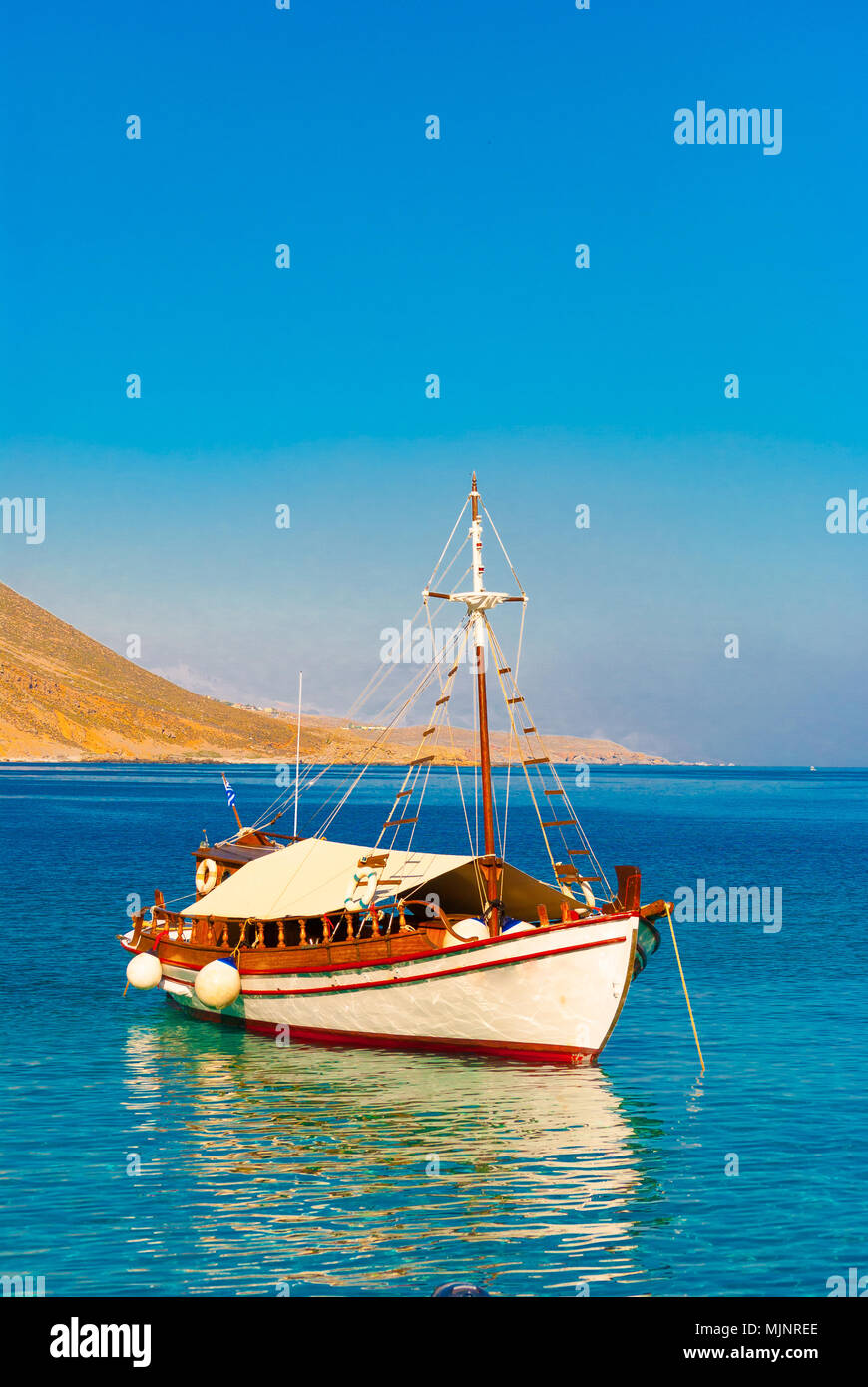 A traditional wooden fishing boat sailing in south Crete of Greece near ...