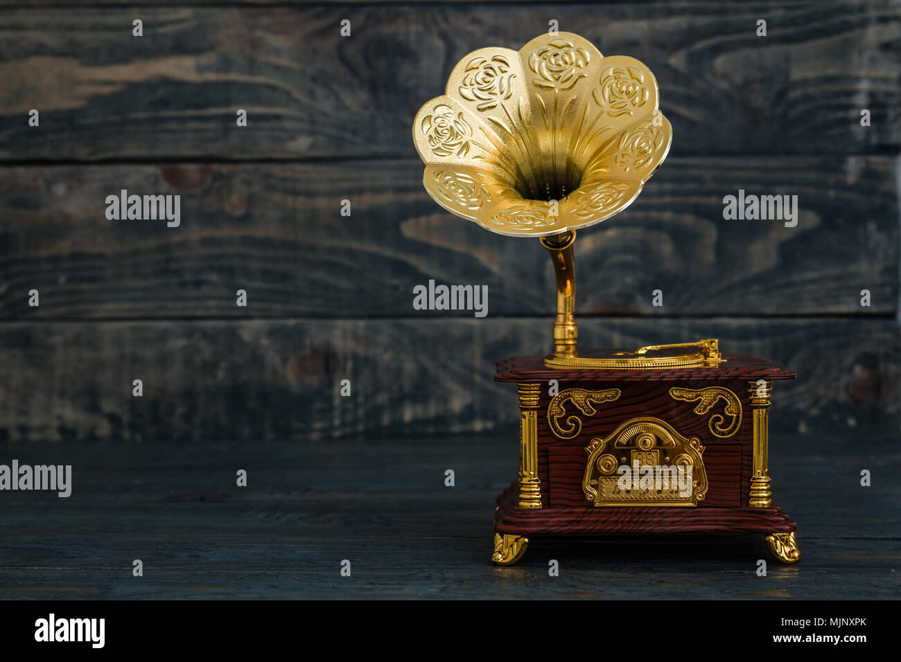 Vintage phonograph gramofon music box on wooden background Stock Photo ...