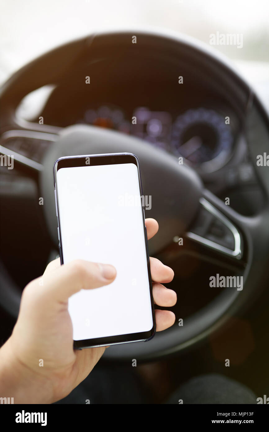 Mockup of using phone in car wheel blured background Stock Photo - Alamy