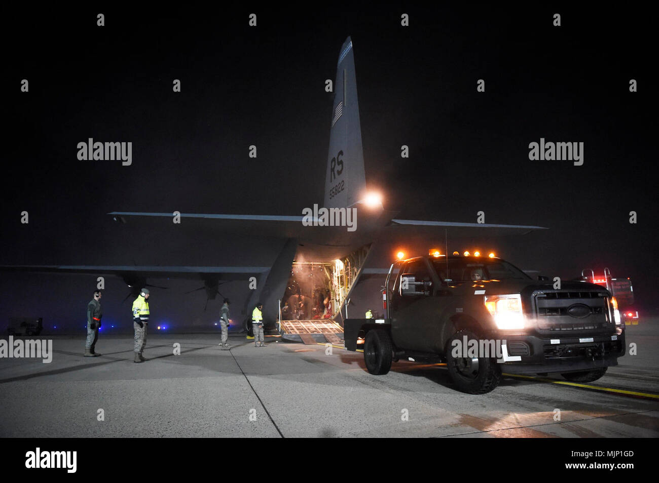 Airmen from the 726th Air Mobility Squadron unload cargo from a C-130 J ...