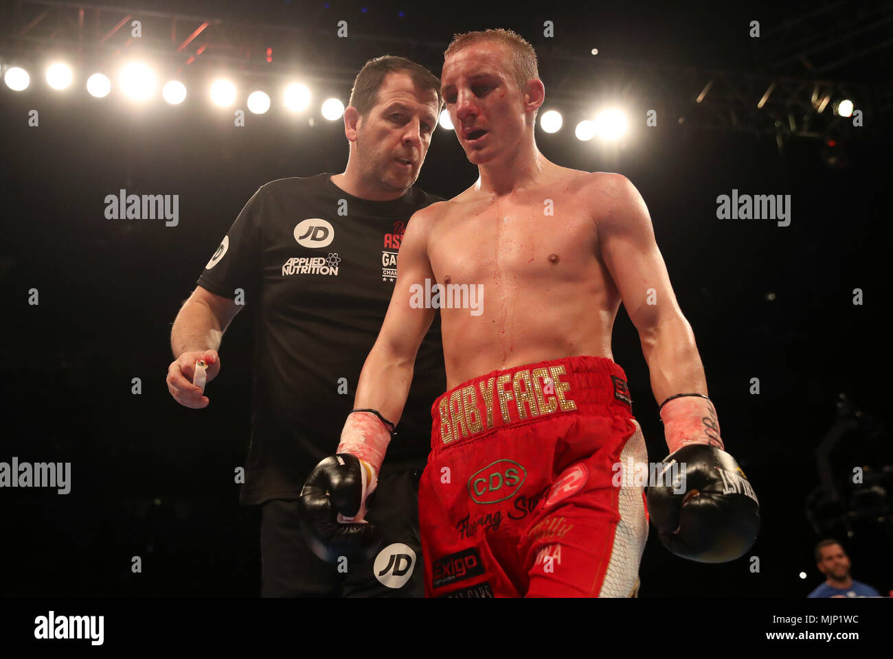 Trainer Joe Gallagher consoles Paul Butler (right) after losing the IBF ...
