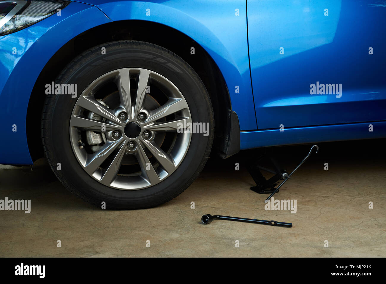 New wheel installed in car. Replacing damaged wheel from bad condition ...