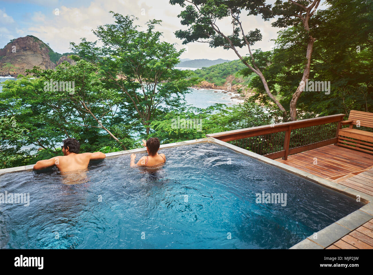 Young couple staying in spa resort outdoor pool Stock Photo - Alamy