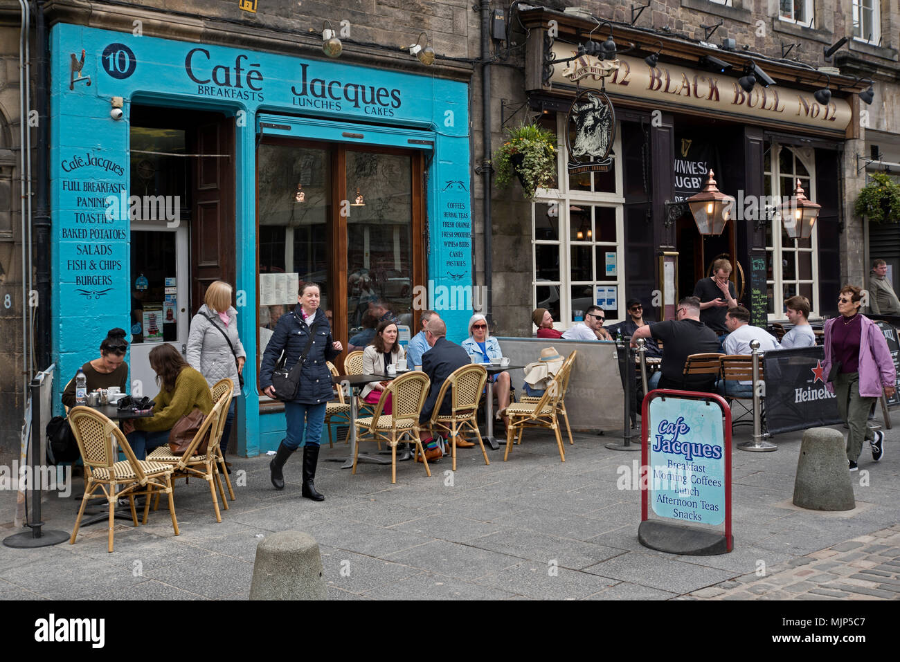 Customers sitting outside Cafe Jacques and the Black Bull piblic house ...
