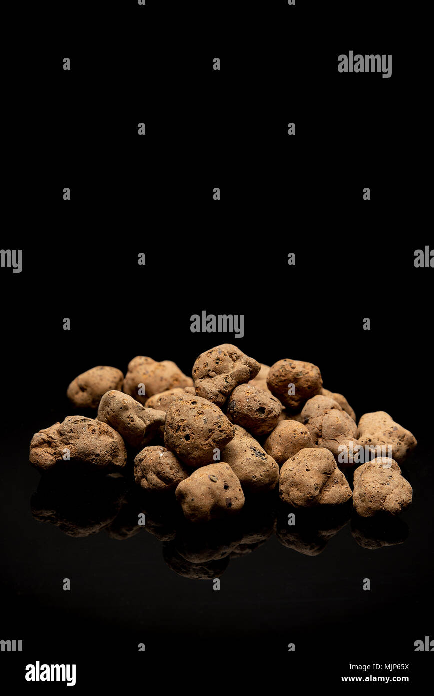 Lightweight expanded clay aggregate on black background, building ...