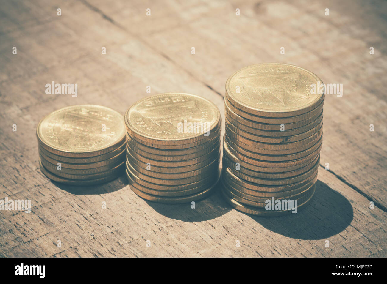 coins on wood with filter effect retro vintage style Stock Photo - Alamy