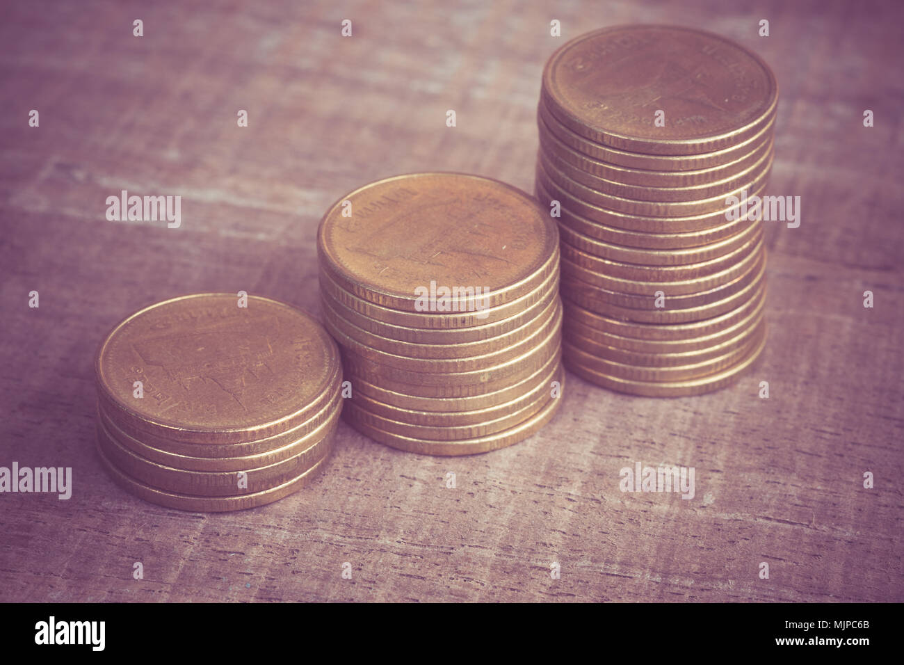 coins on wood with filter effect retro vintage style Stock Photo - Alamy