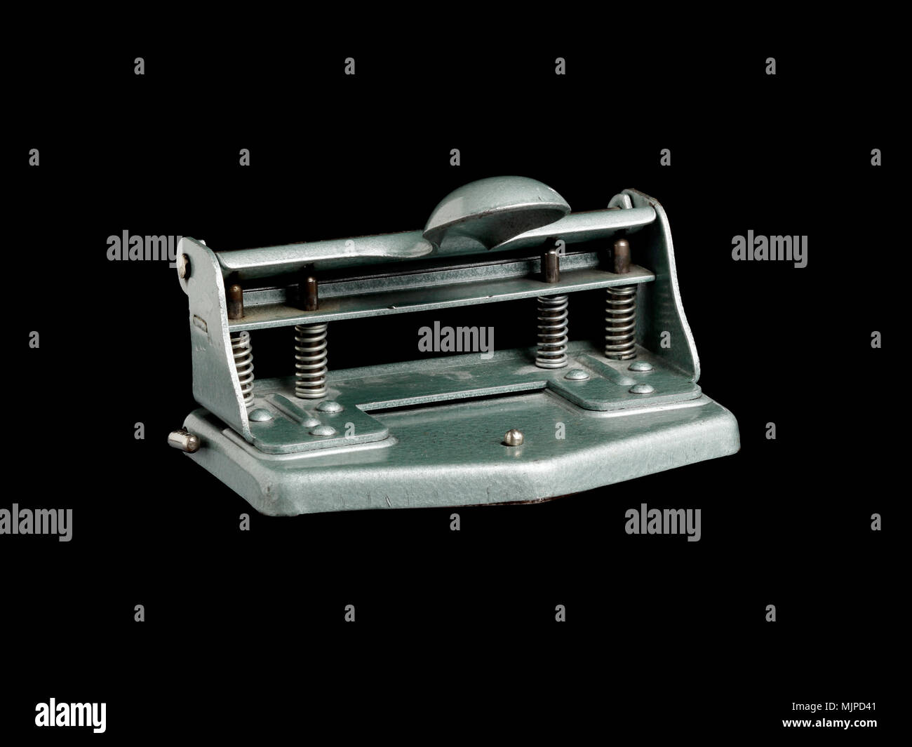 Vintage green metalic paper puncher on black background Stock Photo - Alamy