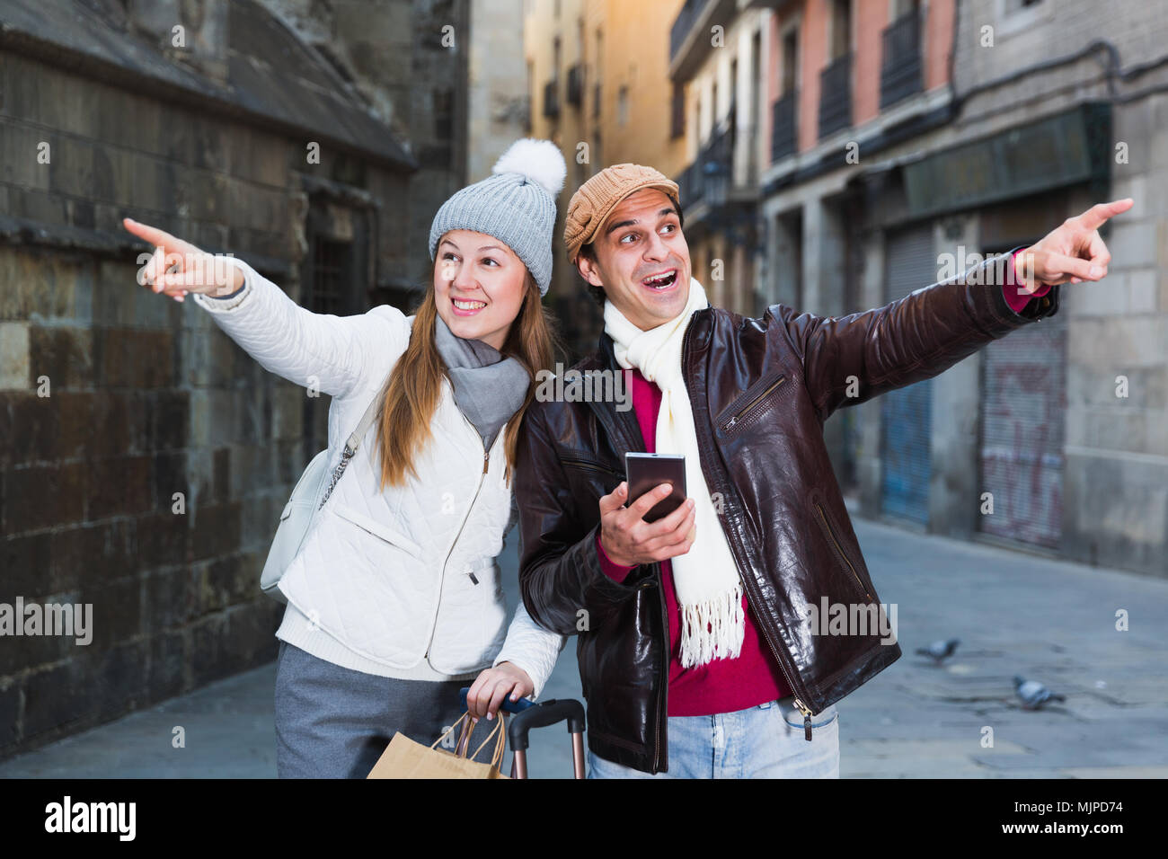 Positive male and female in the historic center pointing finger Stock ...