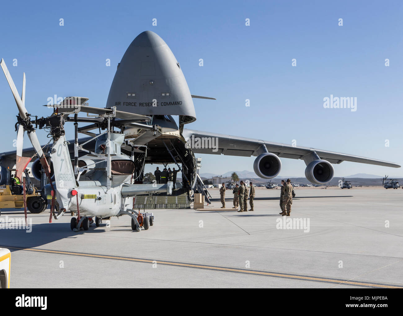 U.S. Marines with Marine Aircraft Group (MAG) 39 assist in transporting ...