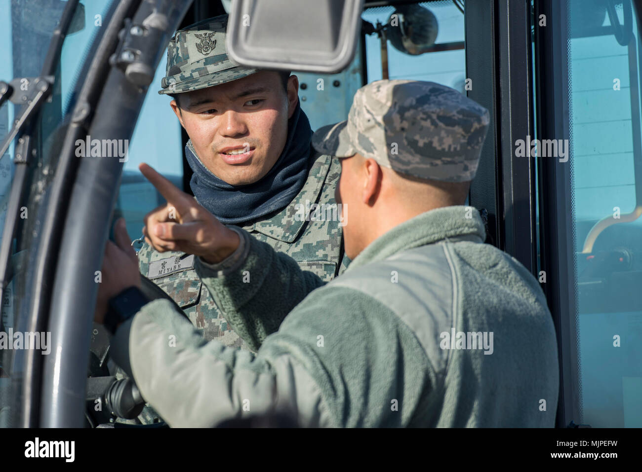 A U.S. Air Force Airman with the 374th Civil Engineer Squadron teaches ...