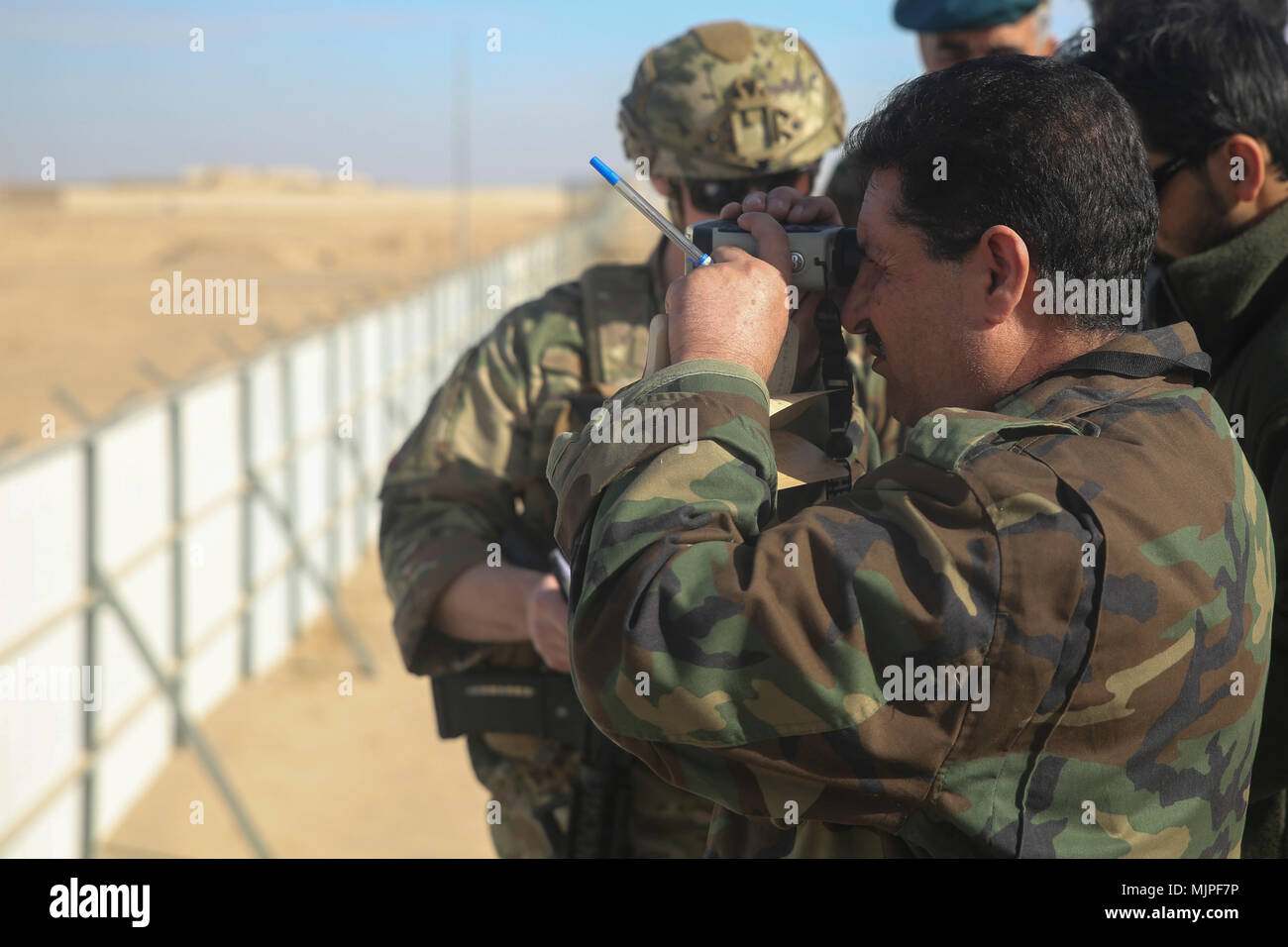 An Afghan Air Force tactical air controller scouts notional targets for ...