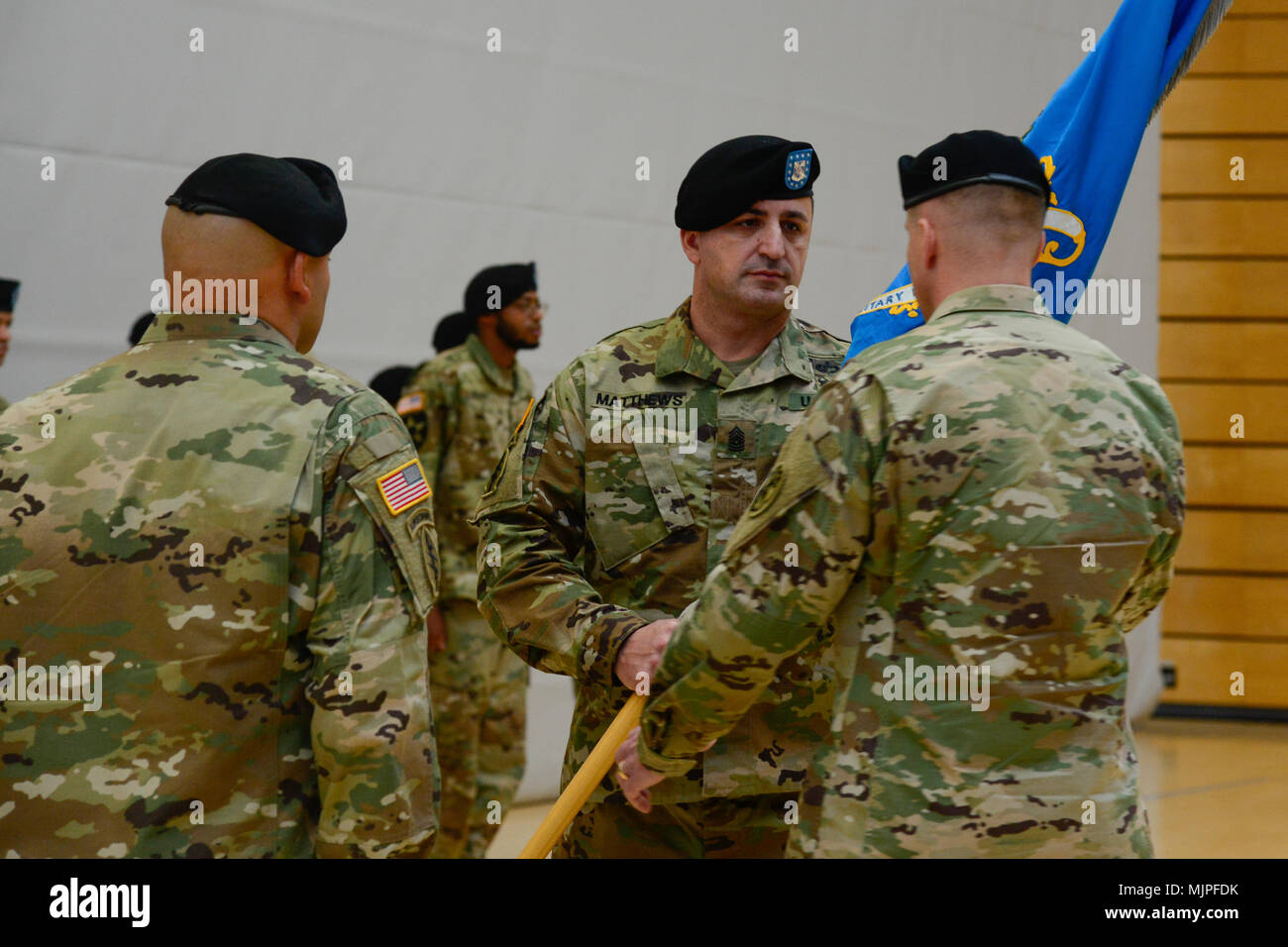 U.S. Army Command Sgt. Maj. Christopher Matthews, center, the outgoing ...