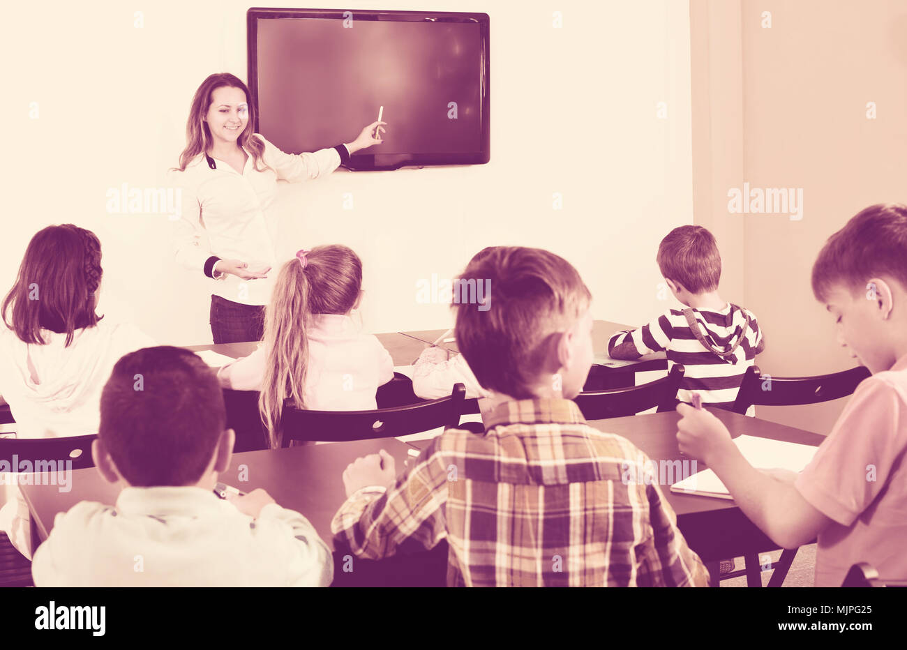 Little children with teacher at classroom Stock Photo - Alamy