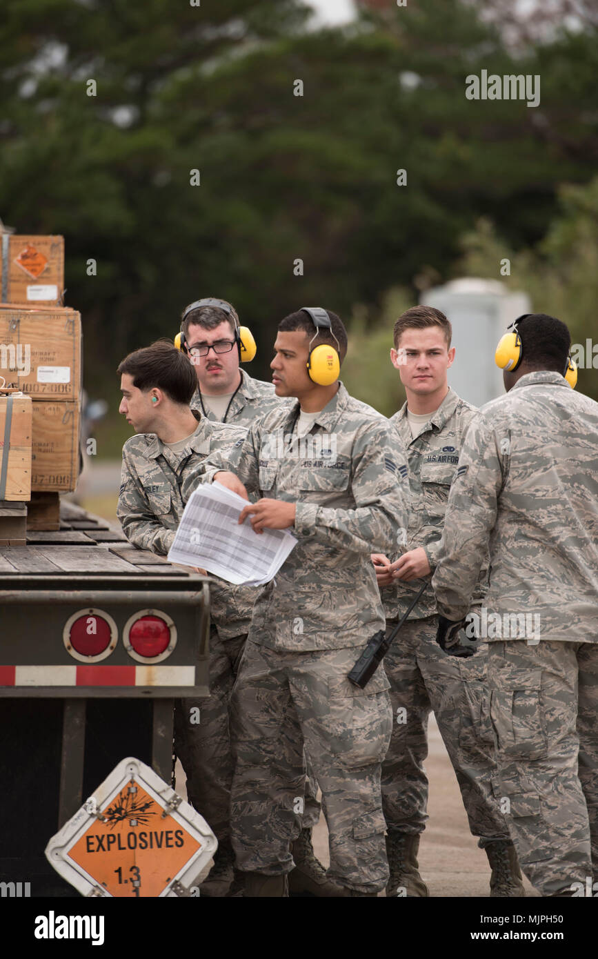 U.S. Air Force Airmen from the 18th Munitions Squadron check serial numbers and other ...