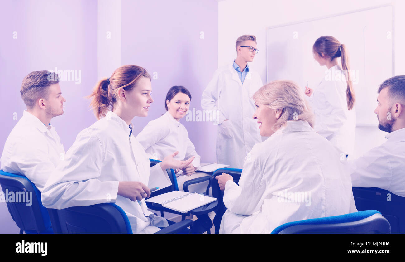 Happy cheerful positive medical students communicating during recess ...