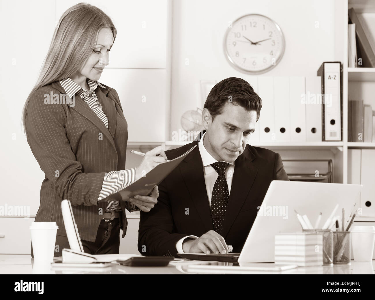 Male boss giving instructions female hi-res stock photography and ...